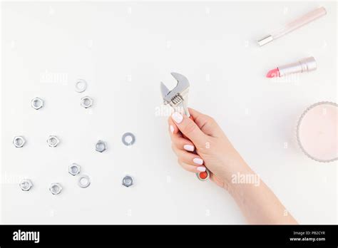 Creative Image Of Woman Hand With Pastel Manicure Polish Holding Spanner With Copy Space Nuts