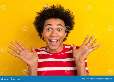 Photo Of Impressed Funky Man Dressed Red T Shirt Smiling Rising Hands