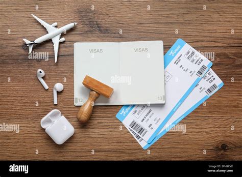 Flat Lay Composition With Passport Stamp And Flight Tickets On Wooden
