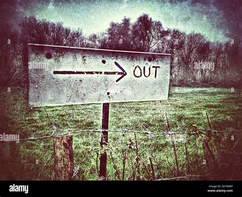 Sign Showing Way Out In Tree Lined Field Stock Photo Alamy