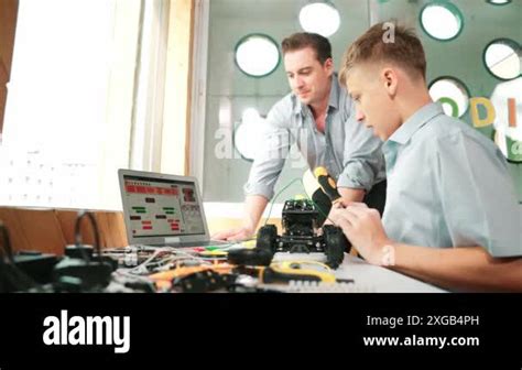 Caucasian Teacher Pointing At Laptop Screen And Giving Advise For