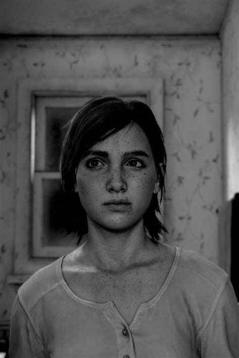 A Black And White Photo Of A Woman With Freckles On Her Face Looking At The Camera