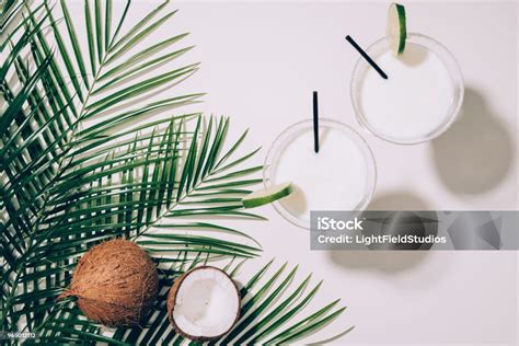 유기농 코코넛 녹색 종 려 잎 및 백색에 빨 대를 마시는와 안경에 코코넛 칵테일의 상위 뷰 0명에 대한 스톡 사진 및 기타 이미지 Istock