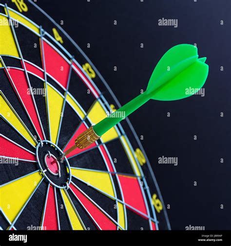 Dart Arrow Hitting In The Target Center Of Dartboard Stock Photo Alamy