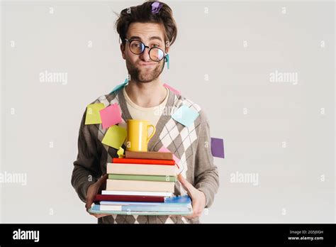 Shocked Nerdy Man Holding Stack Of Books Isolated Over Gray Background Stock Photo Alamy