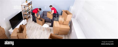 Men Loading The Cardboard Boxes During Moving Stock Photo Alamy