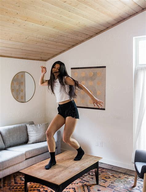 Young Woman Dancing On Coffee Table By Stocksy Contributor Jesse