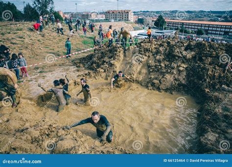 Runners Crossing Mud Pit In A Test Of Extreme Obstacle Race Editorial