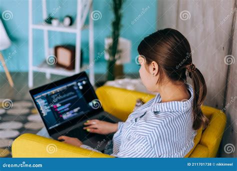 Young Woman Mobile Developer With Laptop Writes Program Code On A