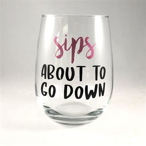 A Wine Glass With The Words Sips About To Go Down Painted On Its Side