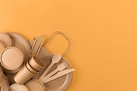 친환경 식기 세트 크래프트 페이퍼 식품 포장 종이 용기 및 컵 복사 공간이있는 오렌지 배경에 빨대를 마시는 길거리 식품 종이