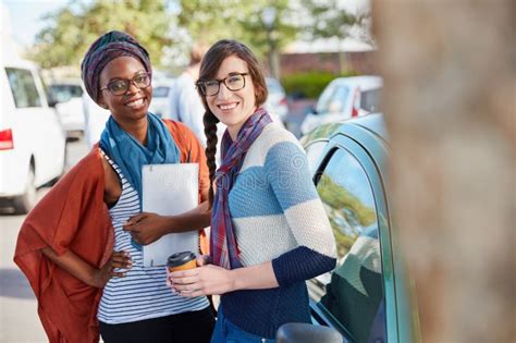 Knowledge Is Empowering Portrait Of Two University Students Hanging