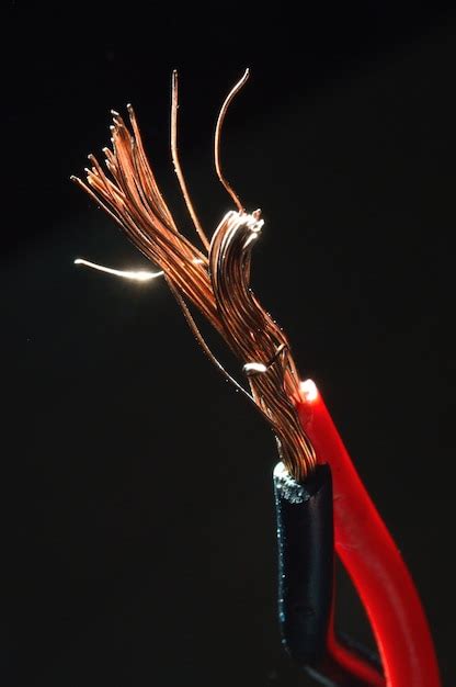 Premium Photo Bare Copper Wires In Black And Red On A Dark Background