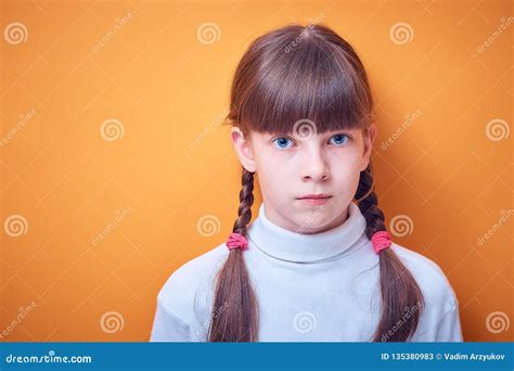 Portrait Of Caucasian Teenage Girl With Two Pigtails On Colored