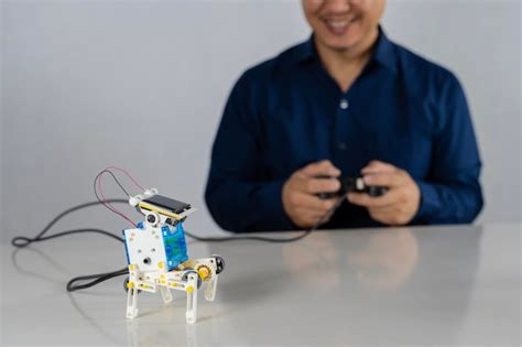 Premium Photo Teacher Collects A Handmade Metal And Plastic Robot