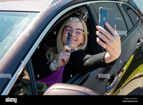 Middle Aged Blonde Woman In Glasses Making Selfie With A Smartphone