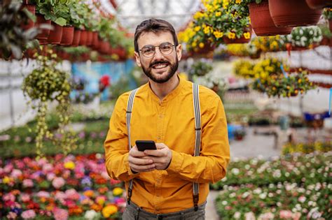 젊은 미소 남성 기업가 핫하우스에 서 서 온라인 주문을 복용 핫하우스 인테리어 Brand Name Online Messaging Platform에 대한 스톡 사진 및 기타