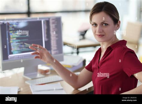 Woman Shows With Pen On Complex Code Developing Software Stock Photo