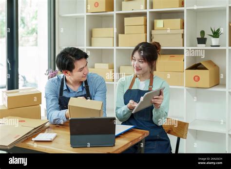 Portrait Of A Small Start Up And Sme Owner An Asian Male And Female Entrepreneur Checking