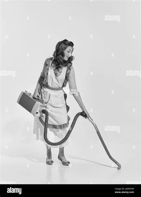 Portrait Of Young Beautiful Retro Woman Cleaning House With Vacuum Cleaner Concept Of Beauty