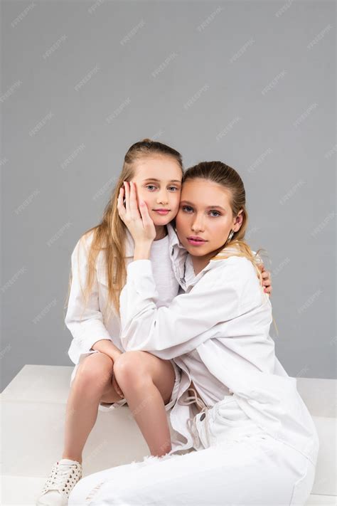 Premium Photo Pleasant Adult Woman Sitting With Her Younger Sister