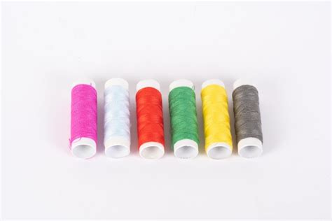 Premium Photo Assorted Spools Of Thread On A White Background