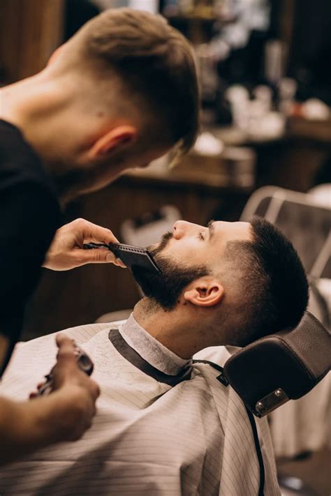 Free Photo Man At A Barbershop Salon Doing Haircut And Beard Trim