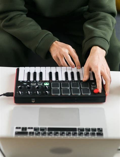 Man Recording Electronic Music Track With Portable Midi Keyboard On