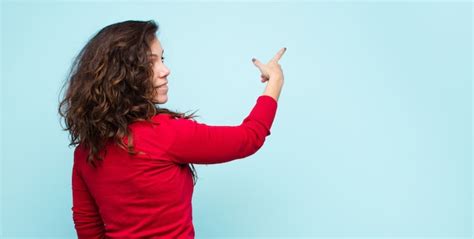 premium photo standing and pointing to object on copy space rear view