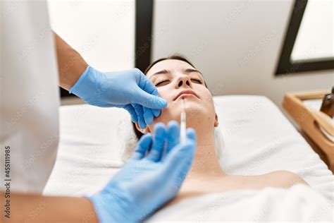 Doctor Man Injecting Botox On Woman Lips For Anti Aging Treatment At The Clinic Stock Photo