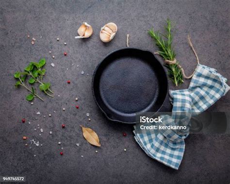 어두운 돌 배경에 빈 오래 된 무 쇠 Skille 스테이크 개념 복사 공간을 만들기 위한 재료입니다 각종 허브와 양념 로즈마리 세이 지 베이 잎 바 질 마늘 및 후추의 열매