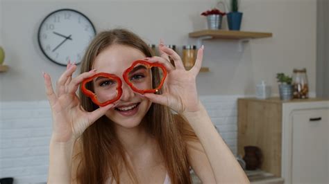 눈에 신선한 빨간 고추 조각을 들고 소녀 비건 춤 체중 감량과 다이어트 라이프 스타일 가리기에 대한 스톡 사진 및 기타 이미지 가리기 가정 주방 가정의 방 Istock