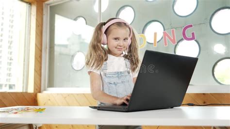 Little Young Cute Girl Using Laptop To Working Or Playing Games
