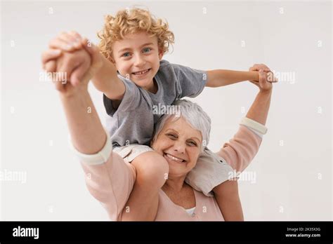 Having Loads Of Fun With Granny A Grandmother Giving Her Grandson A