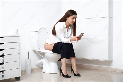 Portrait Of A Businesswoman Sitting On A Toilet With A Your Toilet
