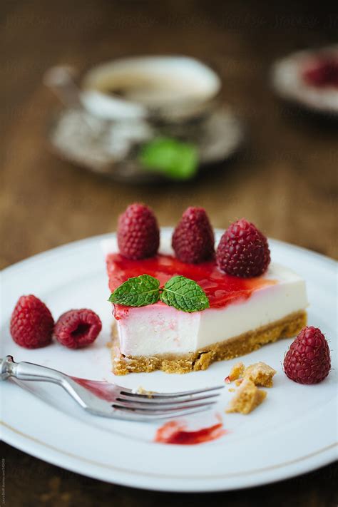 Eaten Raspberry Cheescake Slice With Fresh Mint Leaves By Stocksy