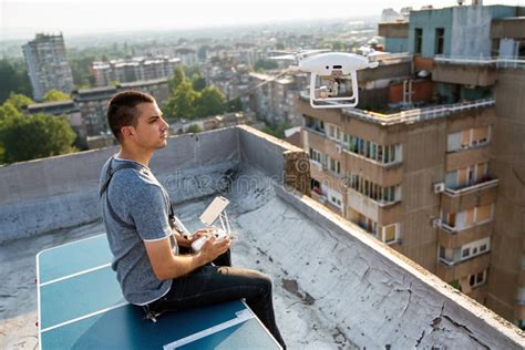 Young Technician Man Flying Uav Drone With Remote Control In City Stock