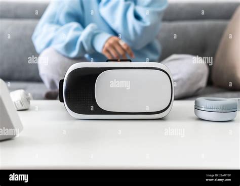 Female Sitting On The Couch In Front Of A Table With Virtual Reality