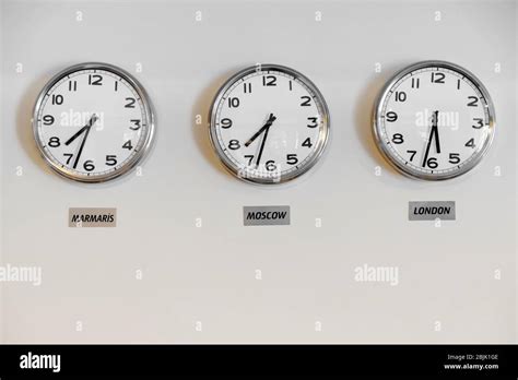 Clocks Showing Time In Different Cities On Wall In Hotel Stock Photo
