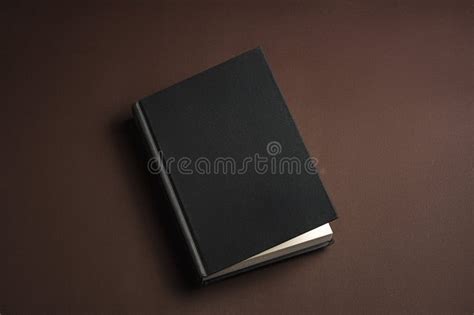 Black Hardcover Book Or Notepad Mock Up On Brown Background Stock Photo