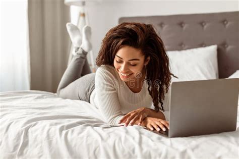 Positive Black Woman Lying In Bed Reading Text Message Stock Image Image Of Lady Cellphone