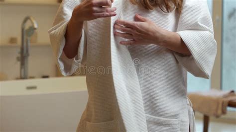 Slender Young Woman Taking Off Her Robe To Take A Relaxing Bubble Bath