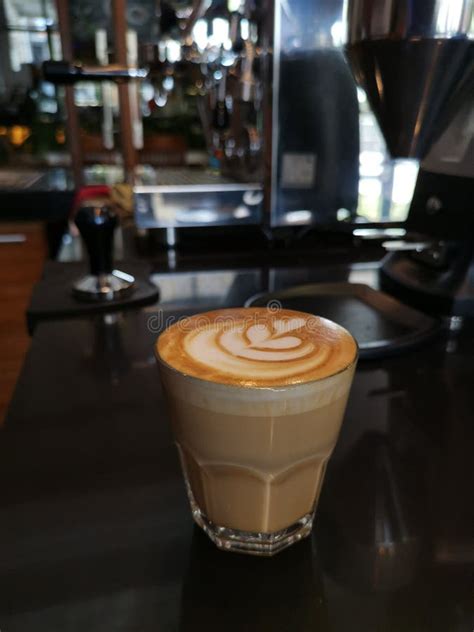 Hot Coffee Latte With Latte Art Served In A Glass On The Table Stock