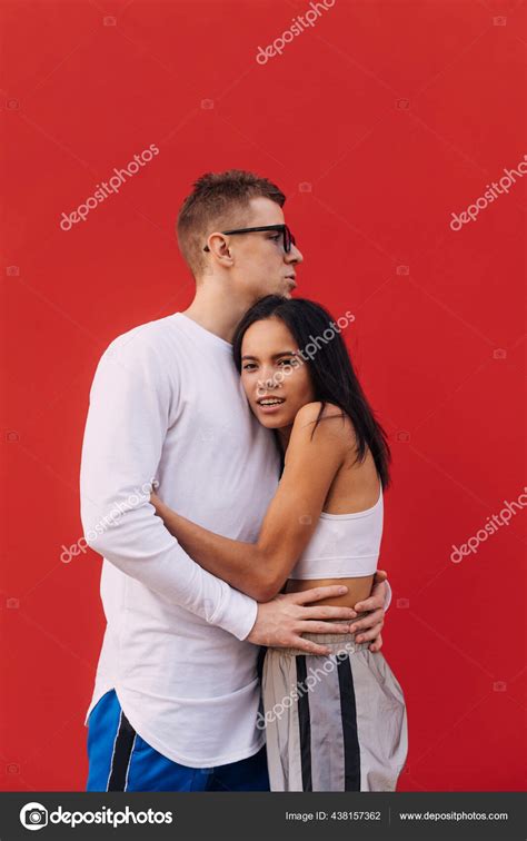 Beautiful Man Woman Stylish Street Clothes Embracing Red Wall