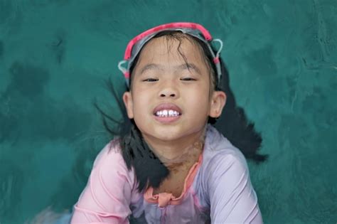 Portrait Of Girl Swimming In Pool Premium Photo