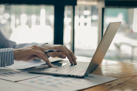 Businessman Hands On Keyboard Of Laptop Computer Showing Data Analysis