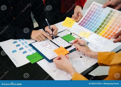 Ux Developer And Ui Designer Brainstorming About Mobile App Interface Wireframe Design With