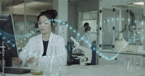 Asian Female Laboratory Scientist Conducts Experiment In Science Lab Looking At Microscope In