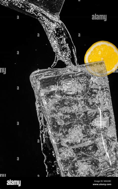 Sparkling Water Overflow Over Ice Cubes Stock Photo Alamy