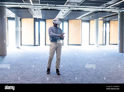 Using Vr Headset Man Exploring Virtual Environment In Modern Office Space Copy Space Stock
